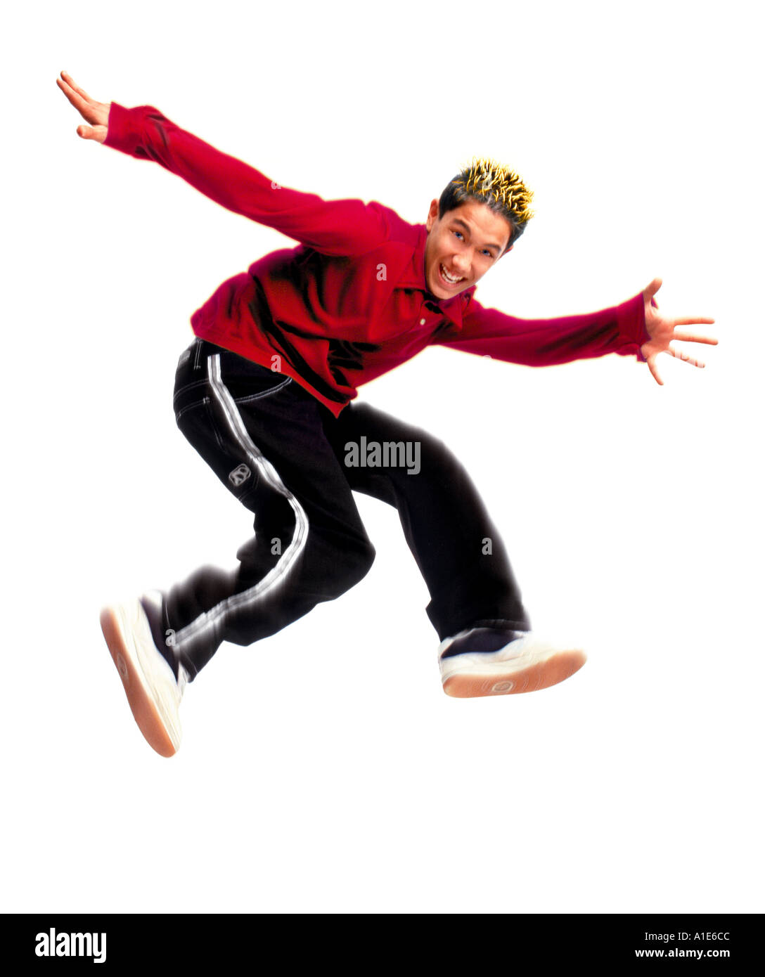 Action shot of Teenage boy jumping smiling to camera Stock Photo - Alamy