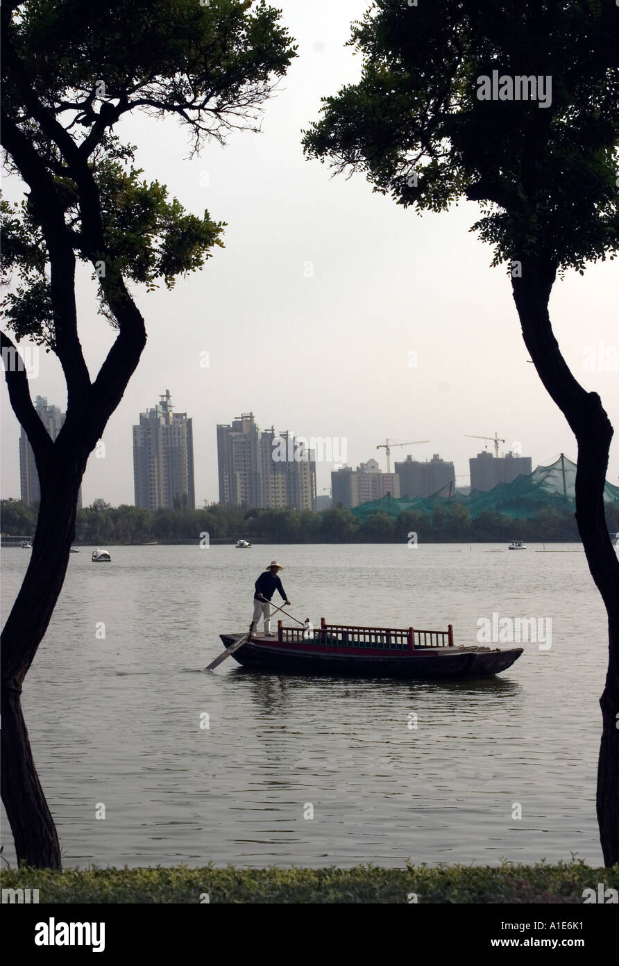 Man in a small boat the Tianjin Lake Tianjin China Stock Photo - Alamy