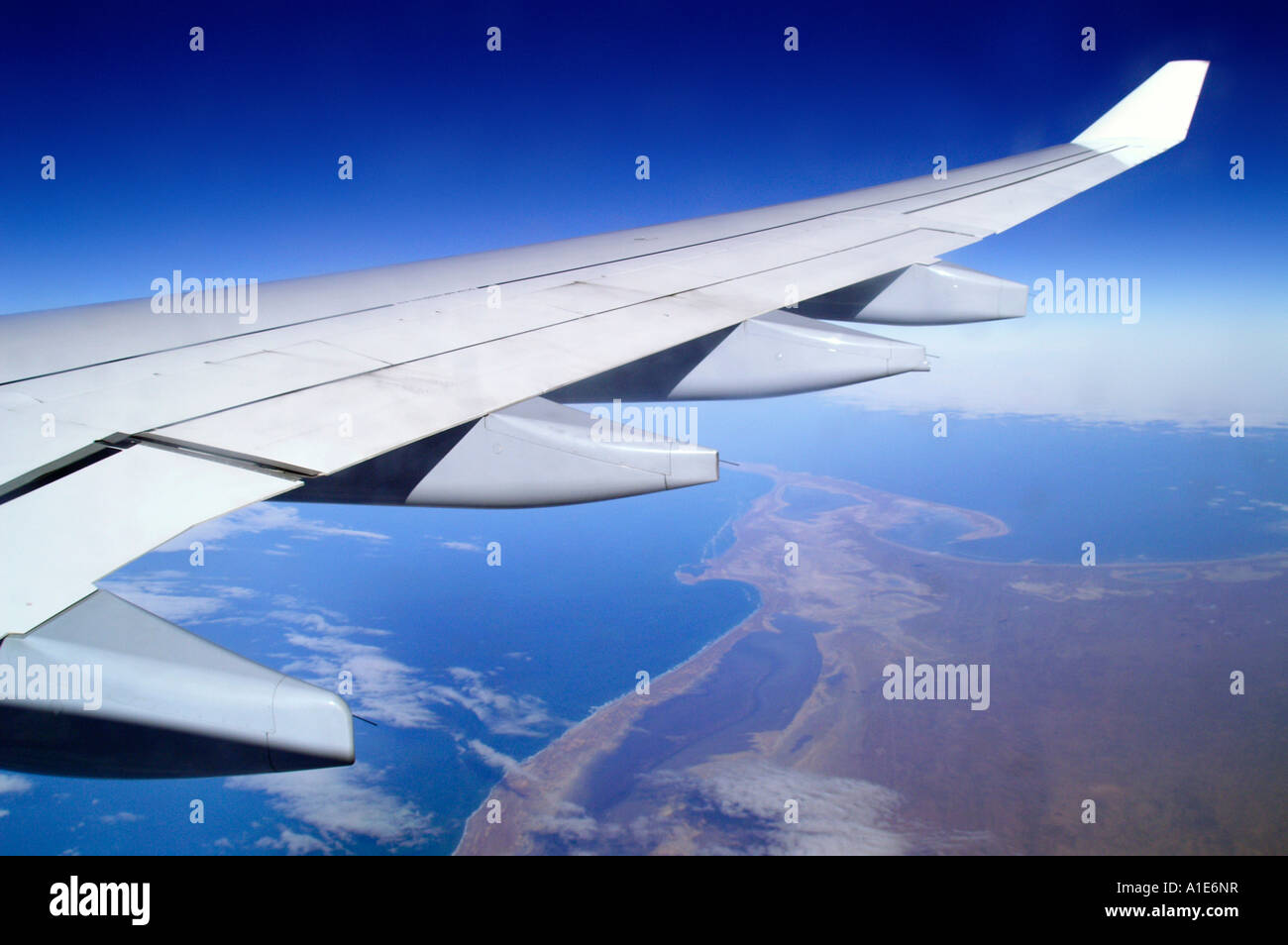 Airbus plane airplane wing above Caspean sea and azure blue sky high ...