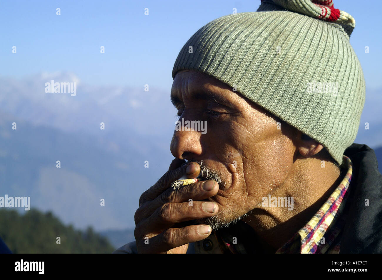 Portrait face of very old indian man highlander smoking at alpine ...