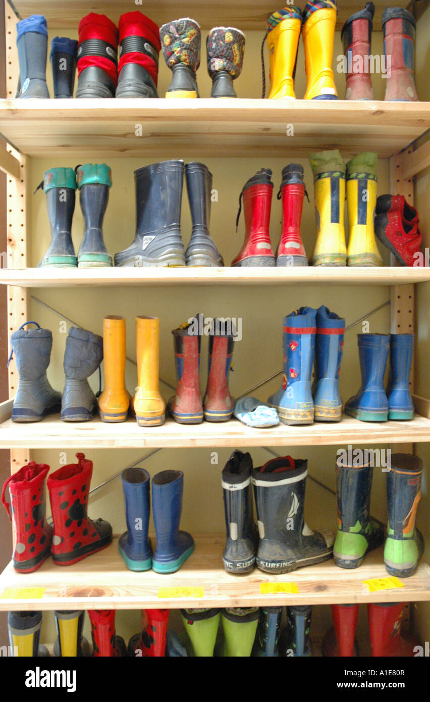 rack with colourful rubber boots in the Kindergarten Stock Photo - Alamy