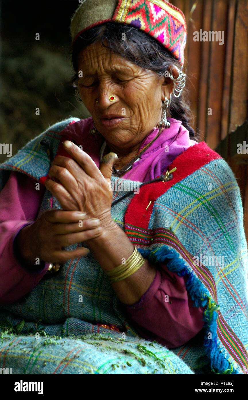 Malanese woman scrubbing hashish resin from her palms - traditional ...