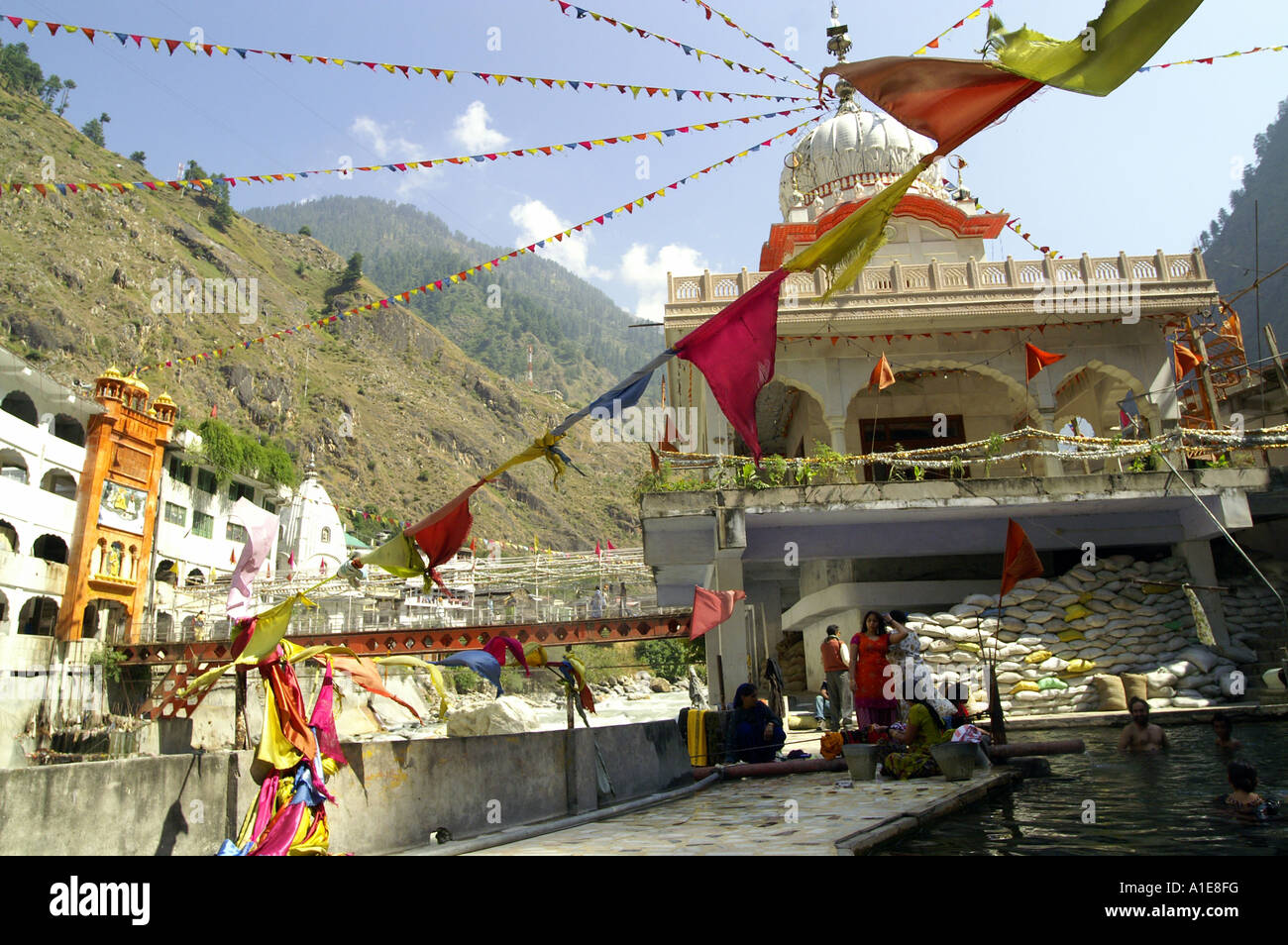 Manikaran hot springs pool public bath and flapping variegated flags ...