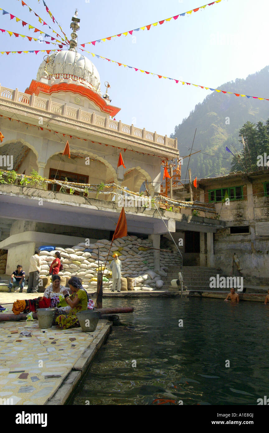 Manikaran hot springs pool public bath and flapping variegated flags ...
