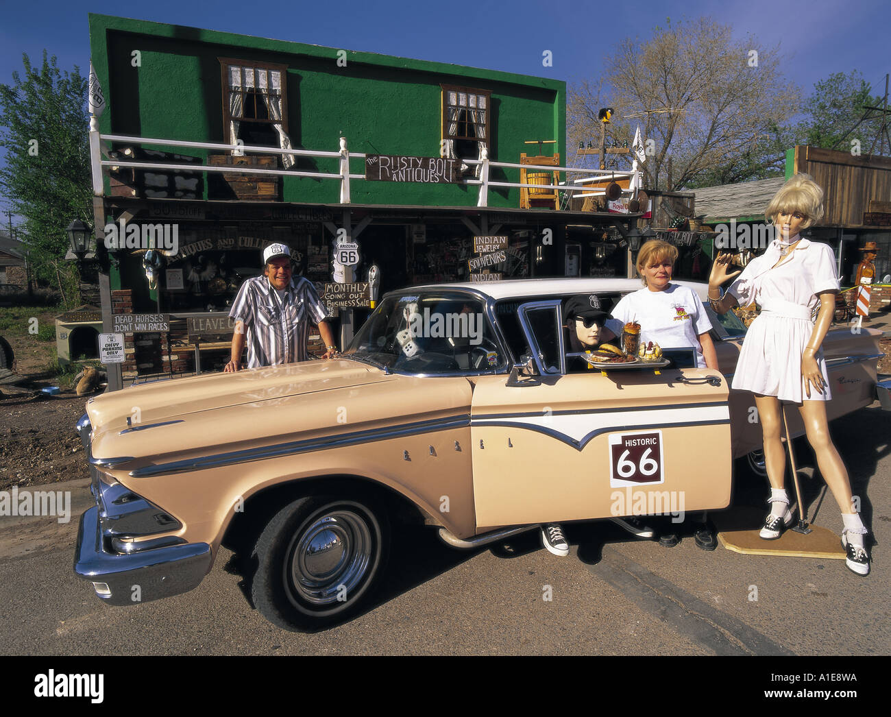 Classic car and mannequins with owners outside general store at Route ...