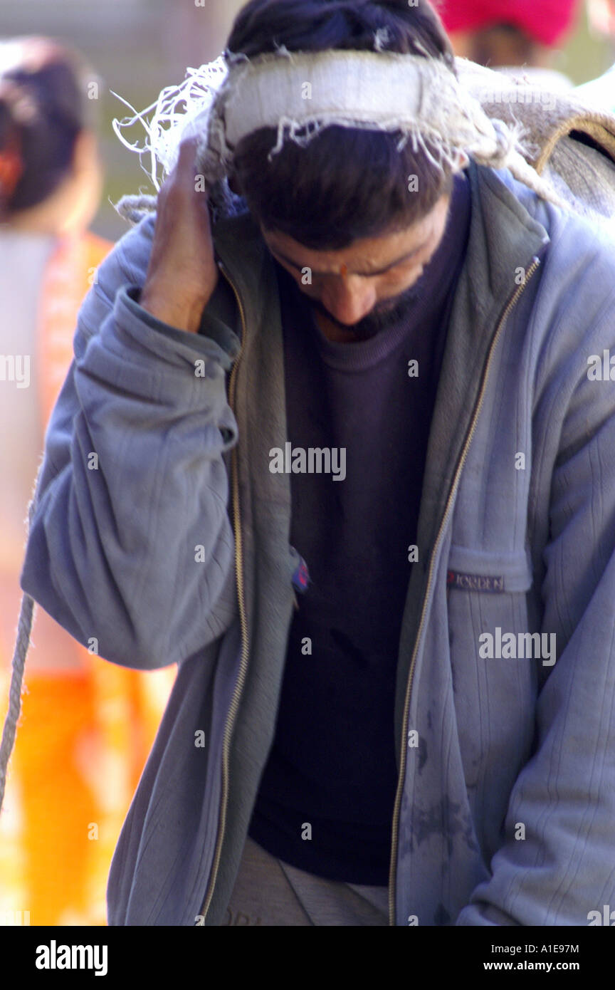 Indian man carrying heavy sack hanged on his head, hard working Stock ...