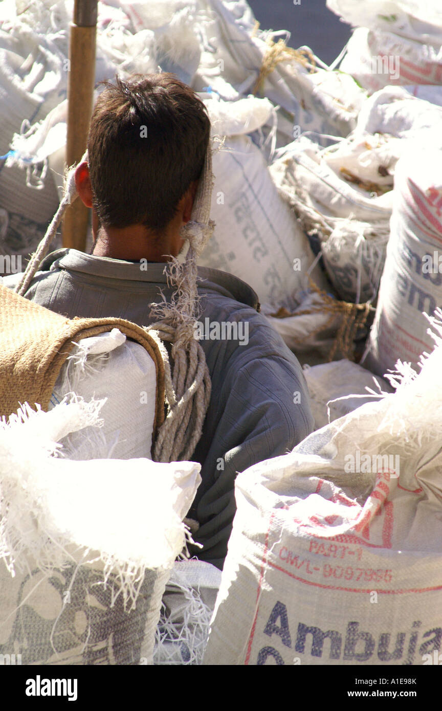 Indian man carrying heavy sack hanged on his head, hard working Stock ...