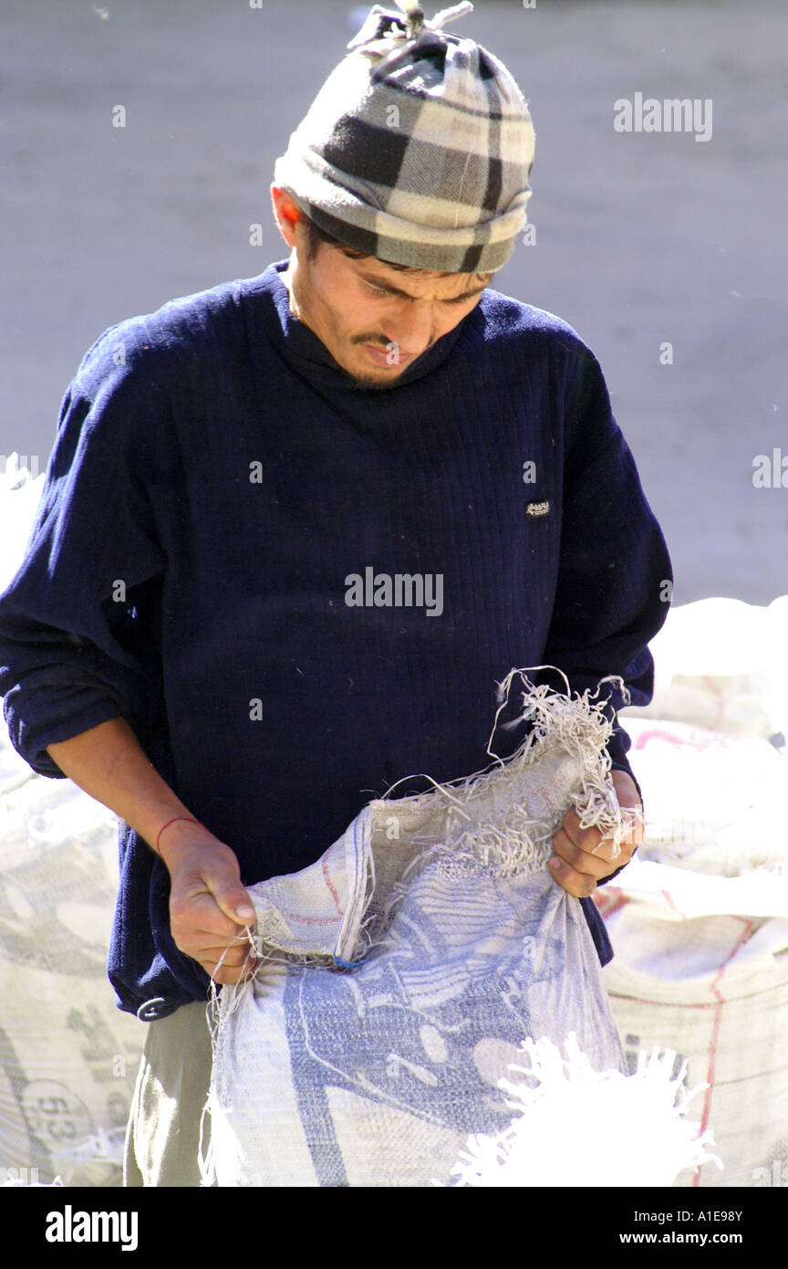 Indian man carrying heavy sack loading, hard working Stock Photo - Alamy