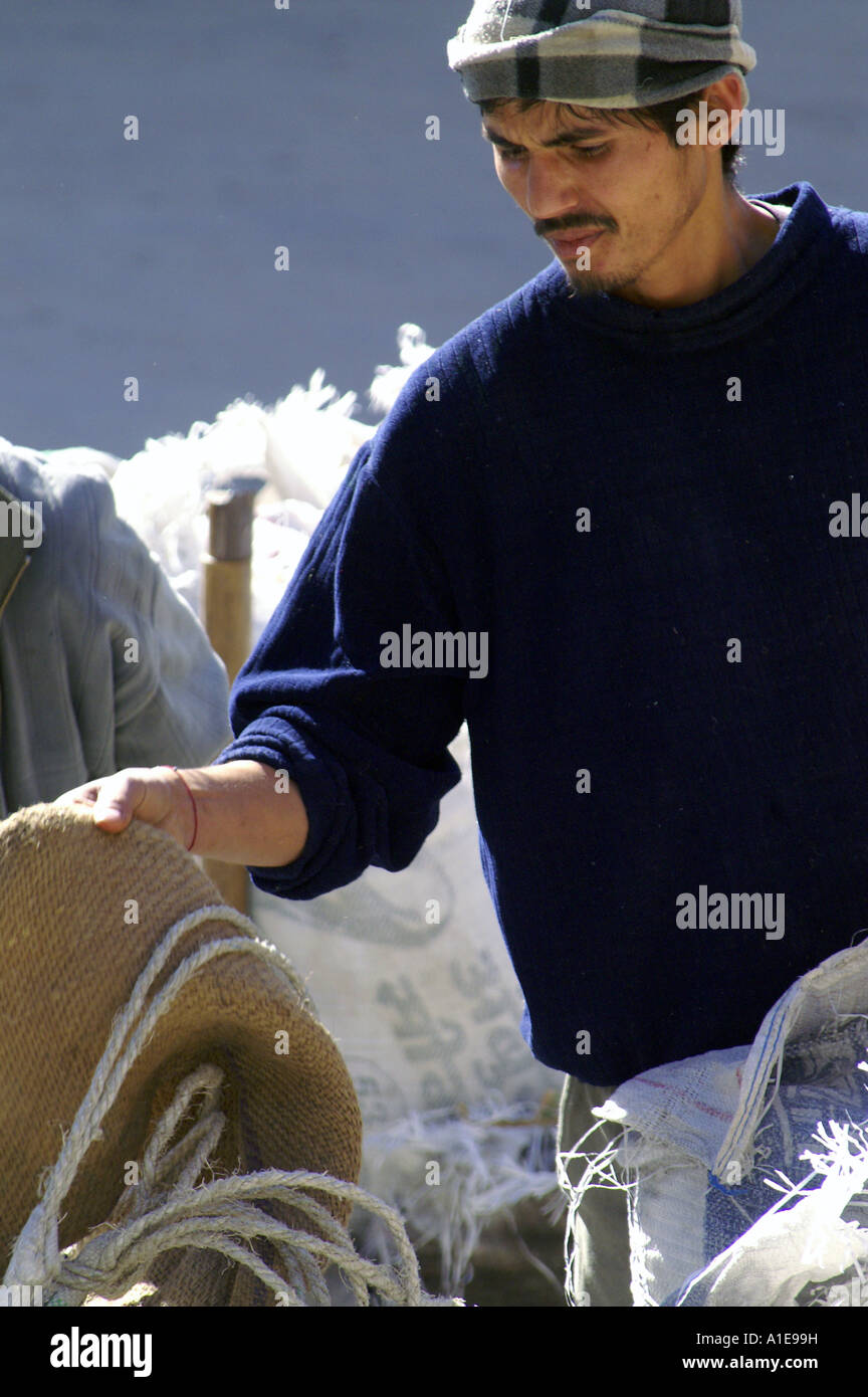 Indian man carrying heavy sack loading, hard working Stock Photo - Alamy