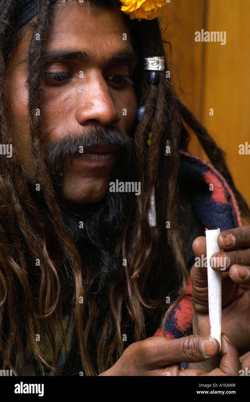 Face portrait smiling sadhu indian man with hashish joint cigarette and ...