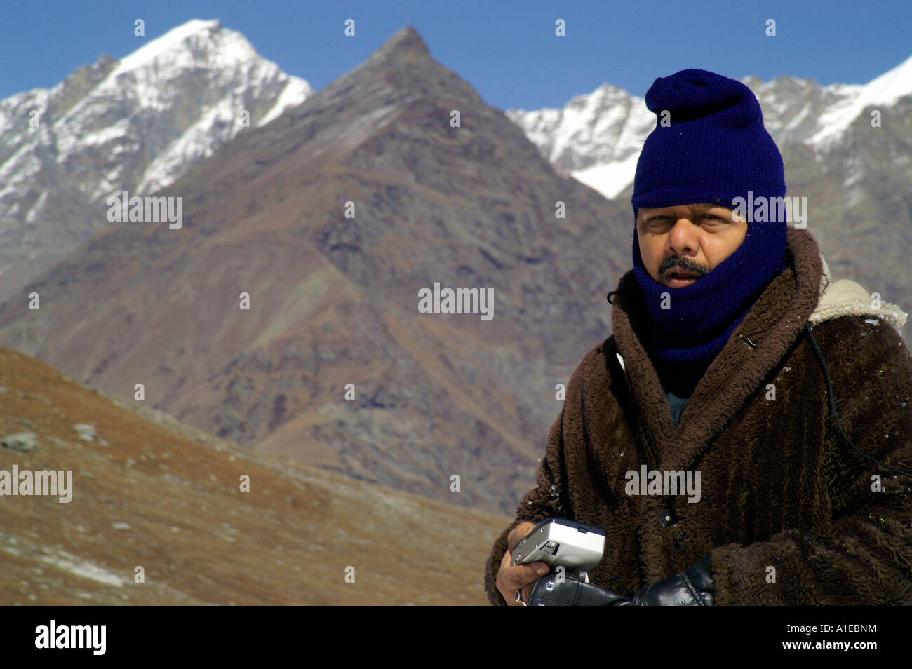 Portrait of typical local indian tourist wearing mask cap in Rohtang ...