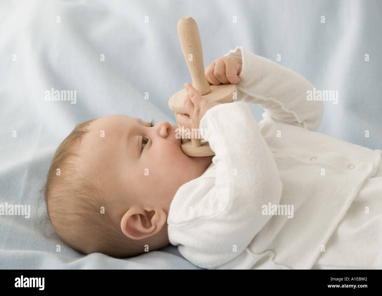 Baby boy holding rattle hi-res stock photography and images - Alamy