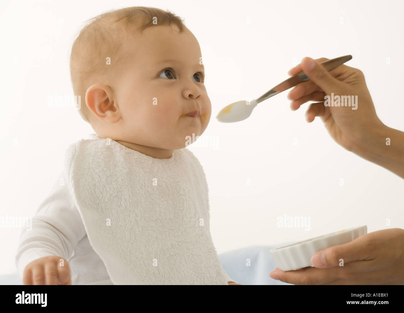 Baby being fed Stock Photo - Alamy