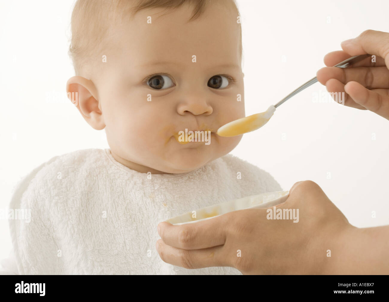 Baby being fed Stock Photo - Alamy
