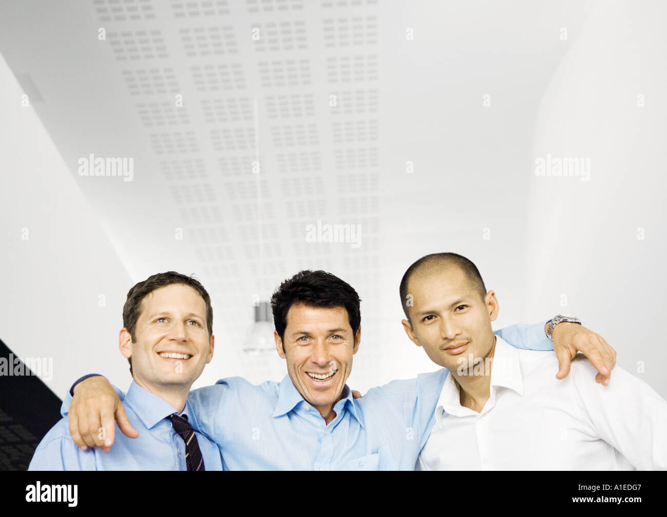Businessman standing with arms around two colleagues shoulders Stock ...