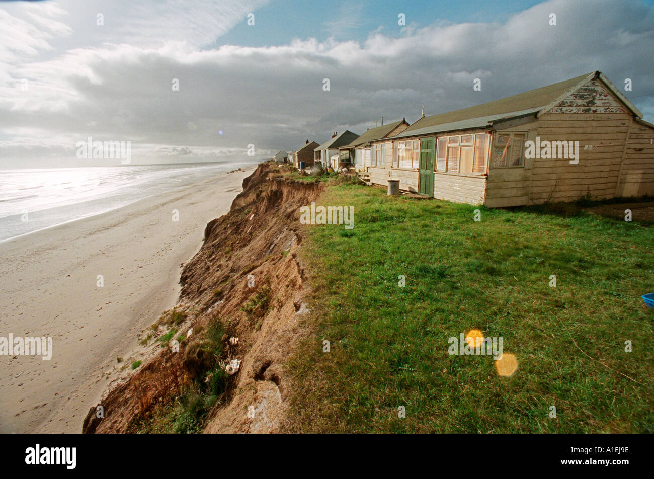 Coastal erosion. Abandoned houses on an unstable cliff edge on the east ...