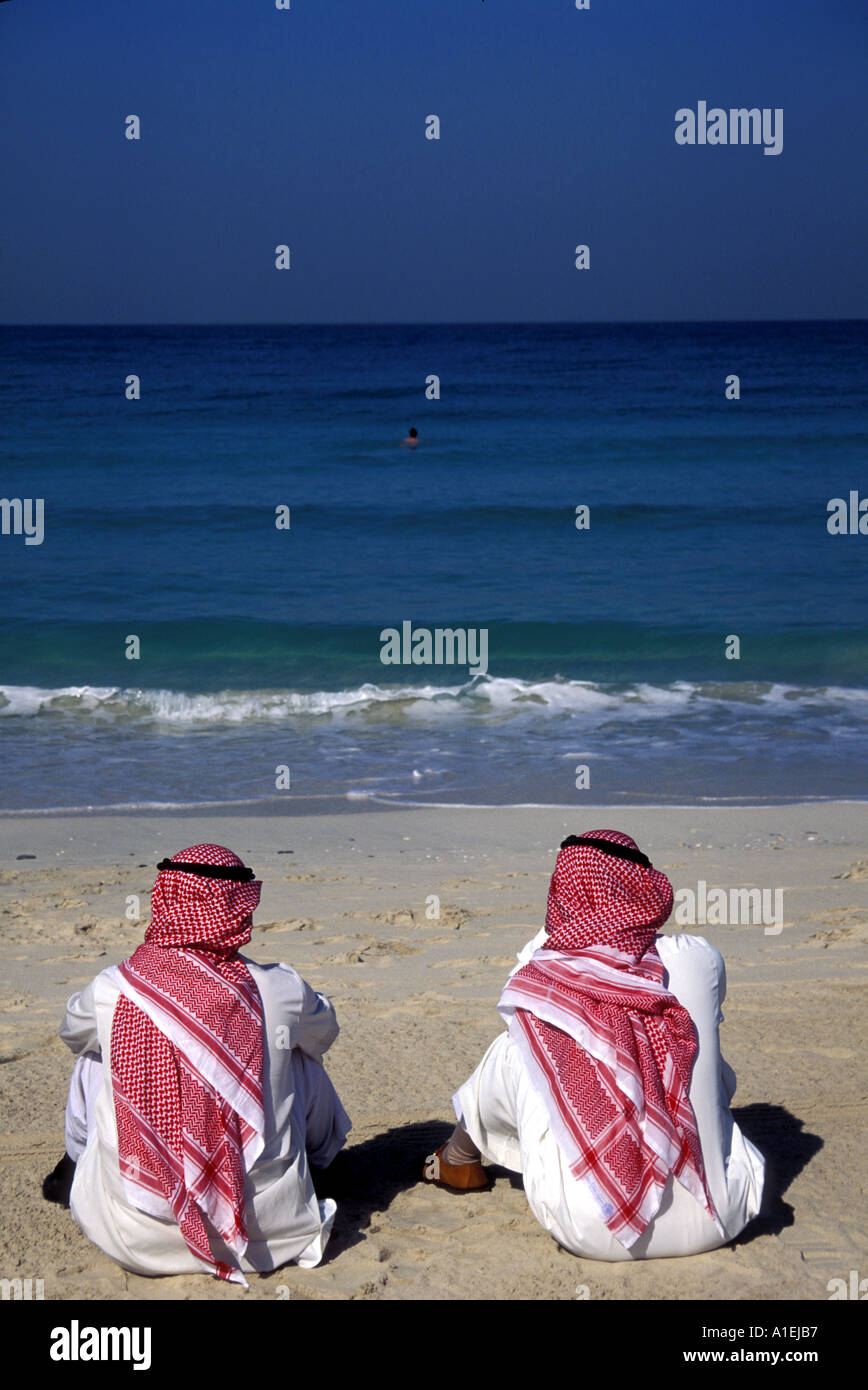 Two local Arabs sitting on Jumeirah Beach in Dubai, UAE Stock Photo - Alamy