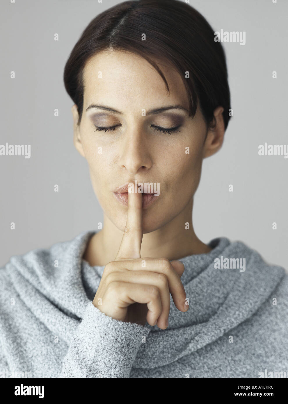 Finger on the lips and eyes closed hi-res stock photography and images ...
