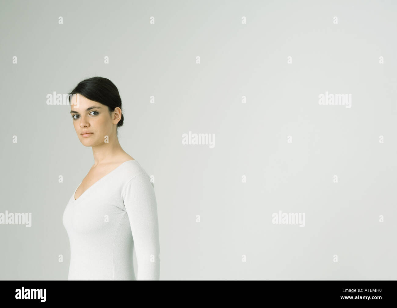 Young woman standing, looking at camera Stock Photo - Alamy