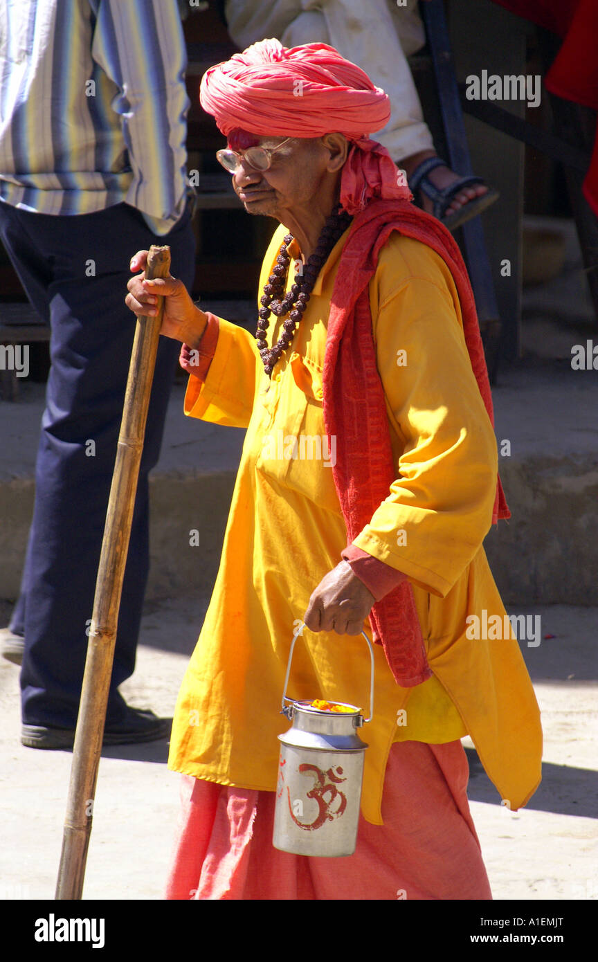 Indian old sadhu holy man walking with stick at Vashist street, India ...