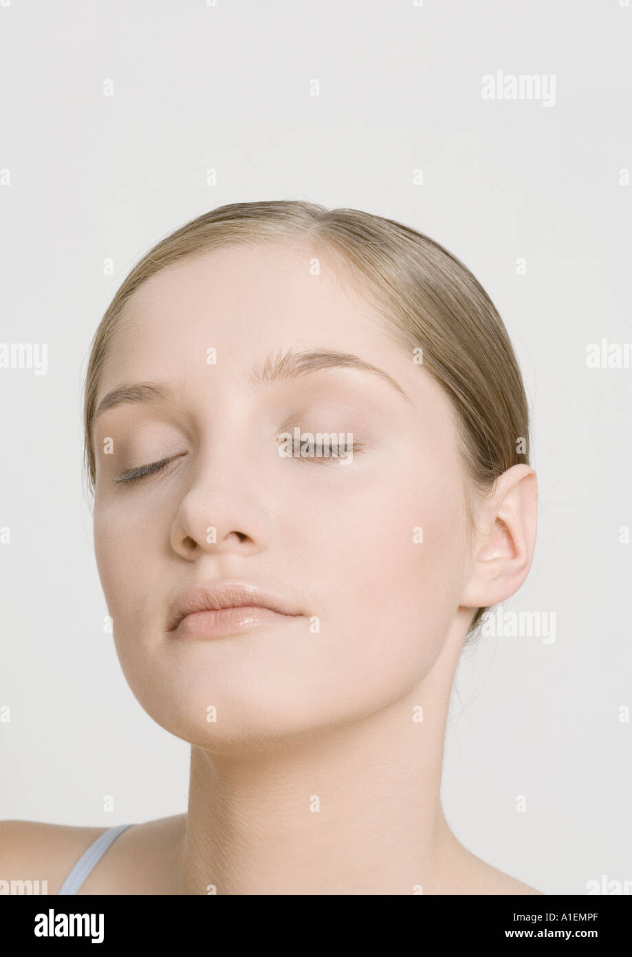Woman closing eyes Stock Photo - Alamy