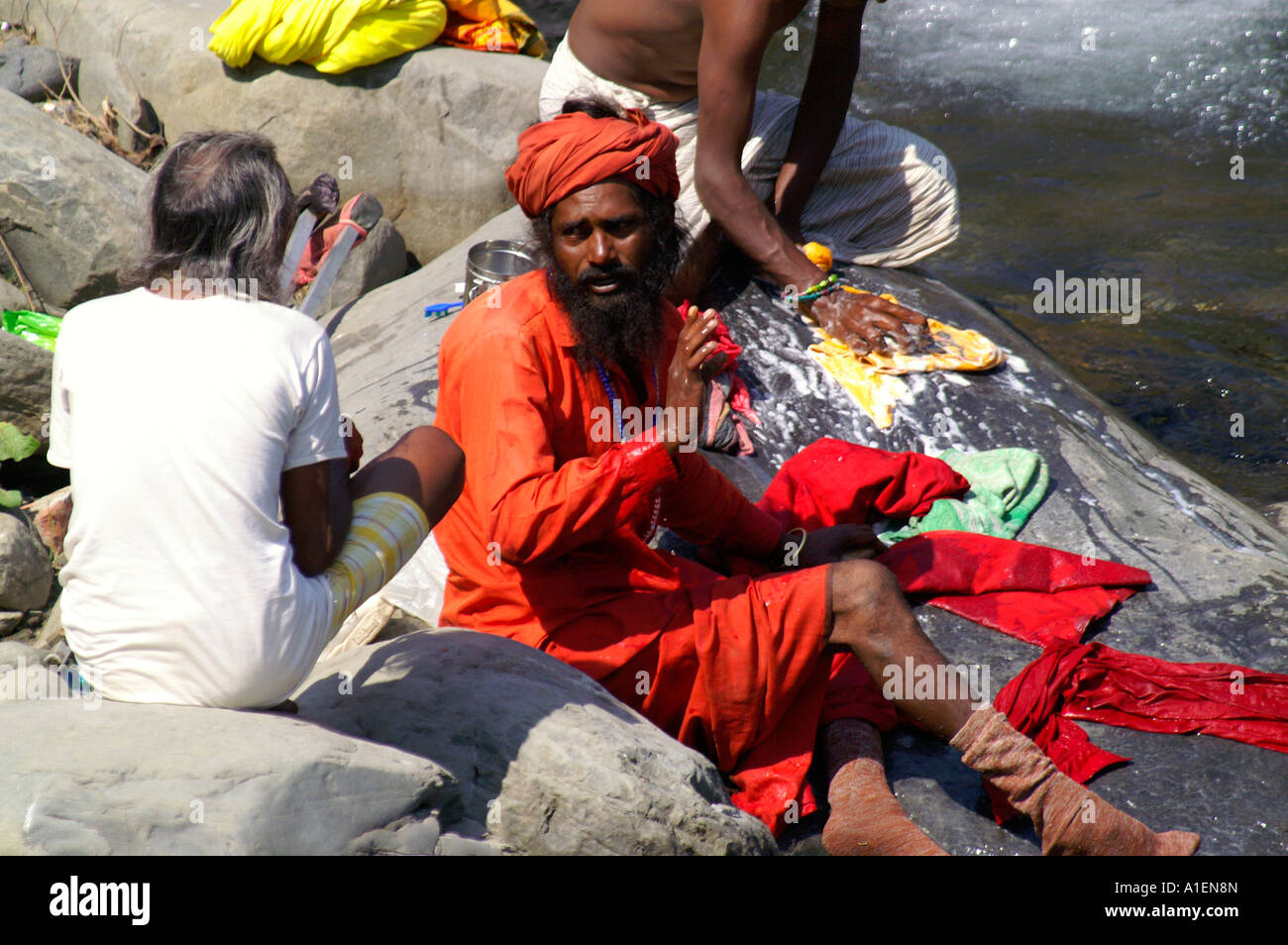 Sadhus religious holy saint yogi magi men doing laundry at bank of ...