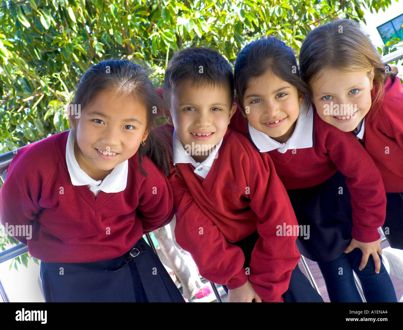 Multicultural group of happy junior school children smile to camera at ...
