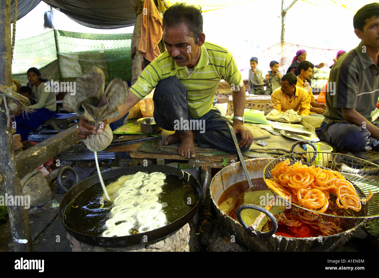 Man cooking pretzels at Dussehra fair with enormous variety of rich ...