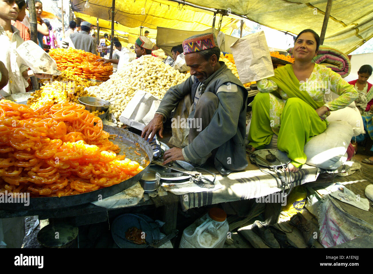 Man cooking sweets at Dussehra fair with enormous variety of rich ...