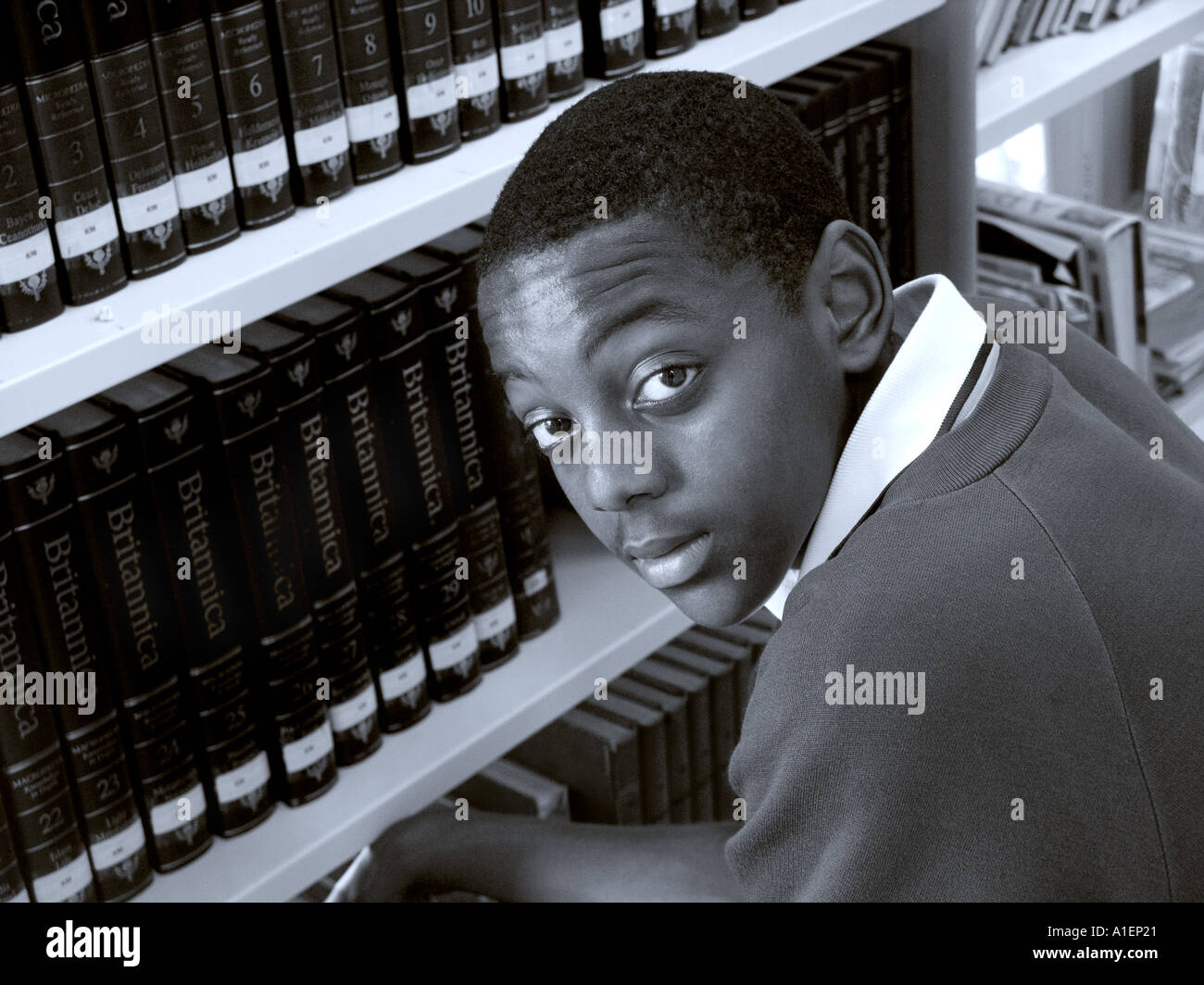 Close up portrait of teenage black male student in school library with ...
