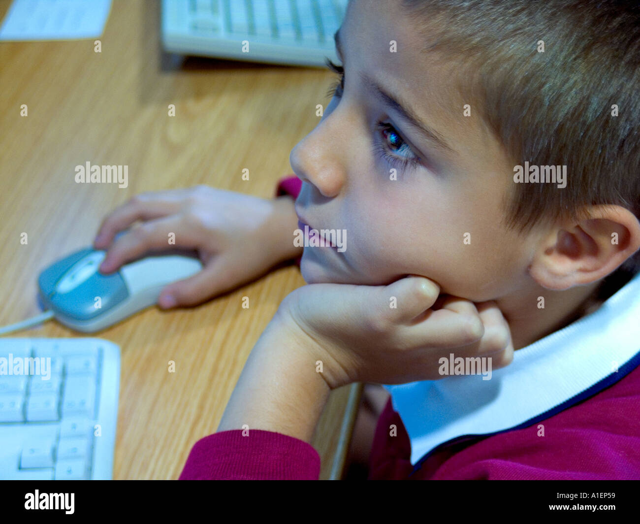 infant schoolboy with computer mouse and keyboard in uniform aged 3 to ...