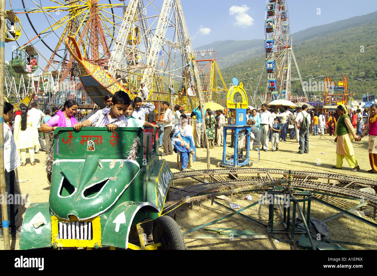 Indian merry go round electric car and giant wheel at Dussehra festival ...