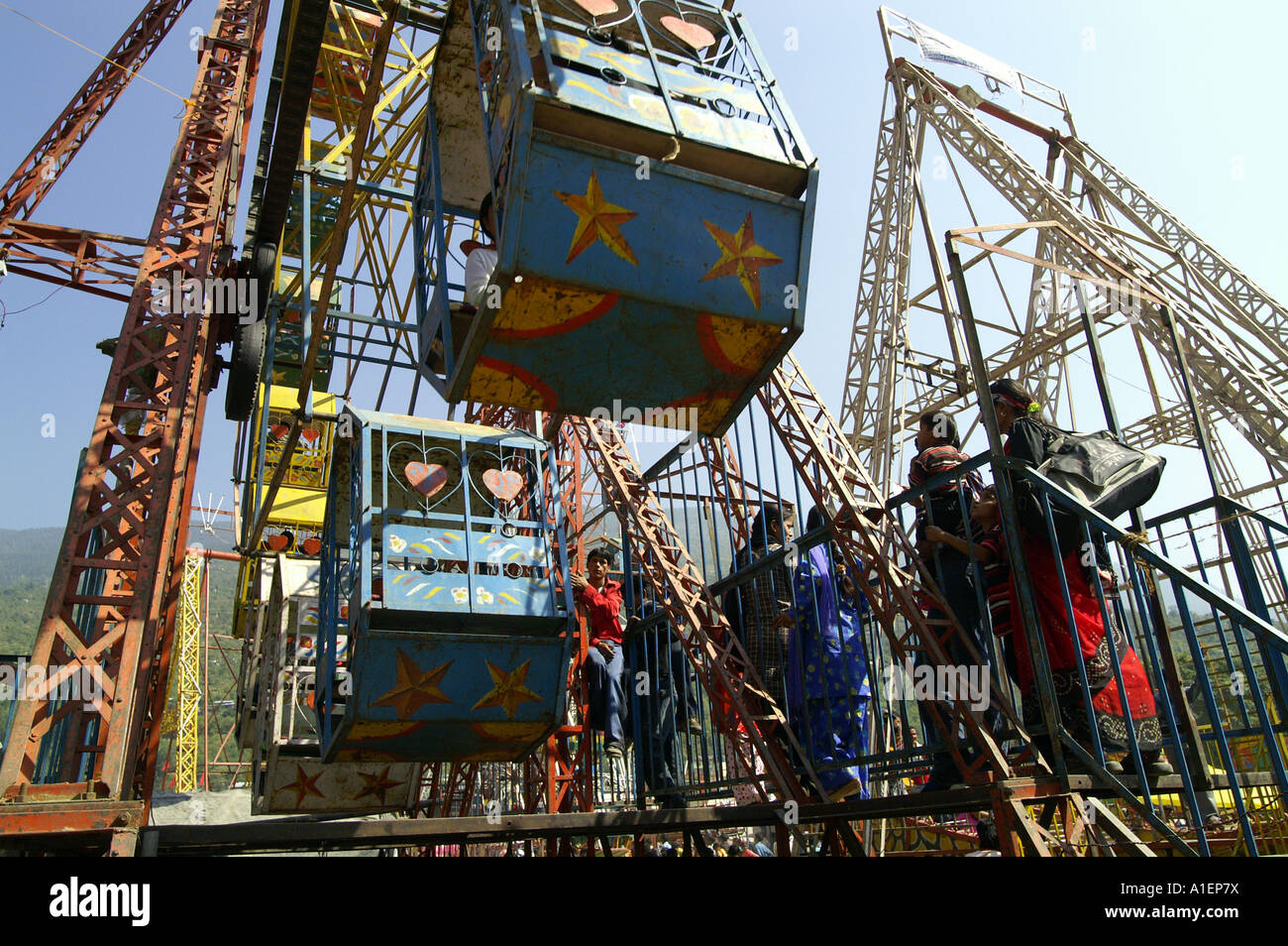 Queue at Indian merry go round at Dussehra festival in Kullu, India ...