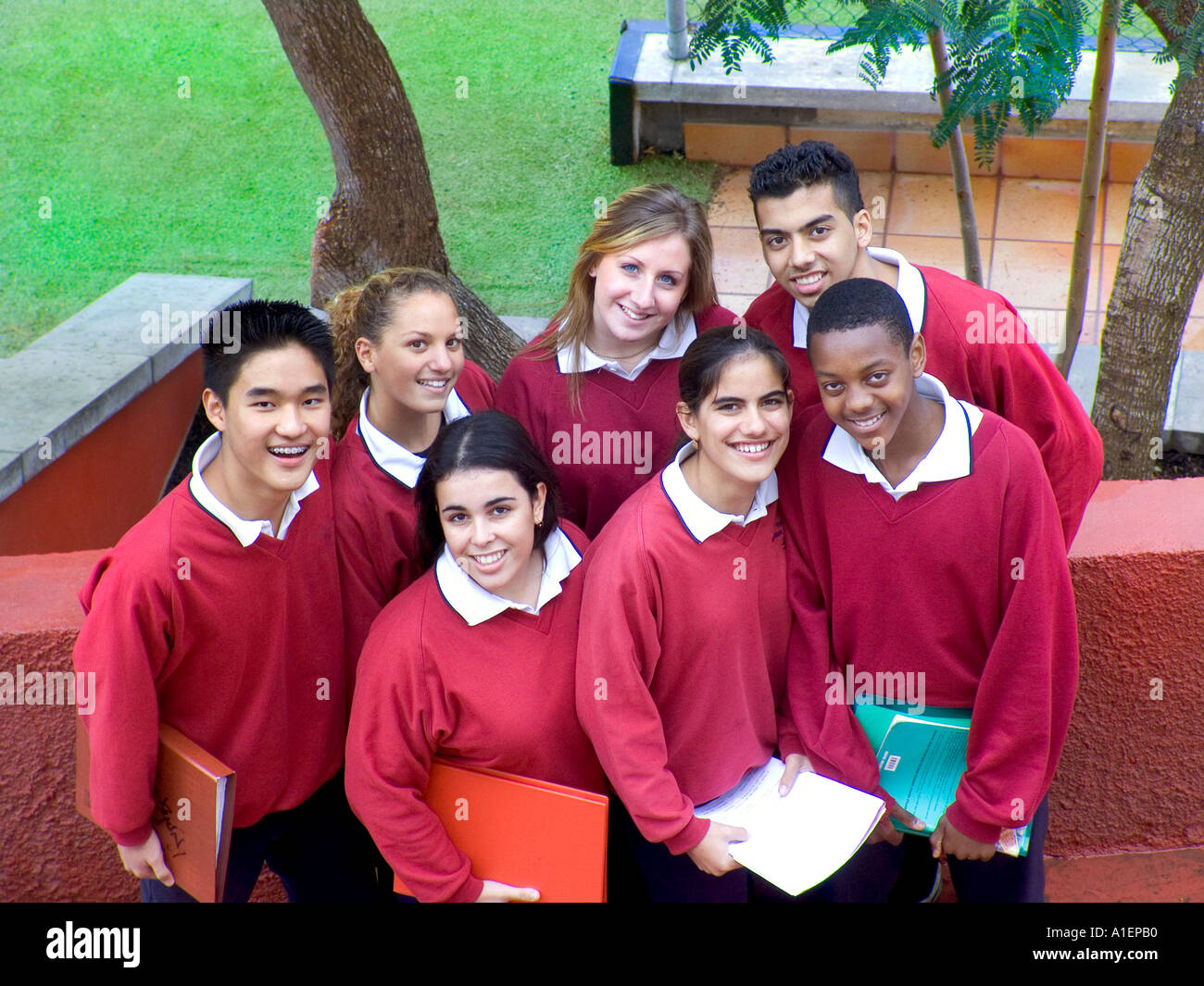 Multicultural group of happy confident ethnic teenage students pose ...