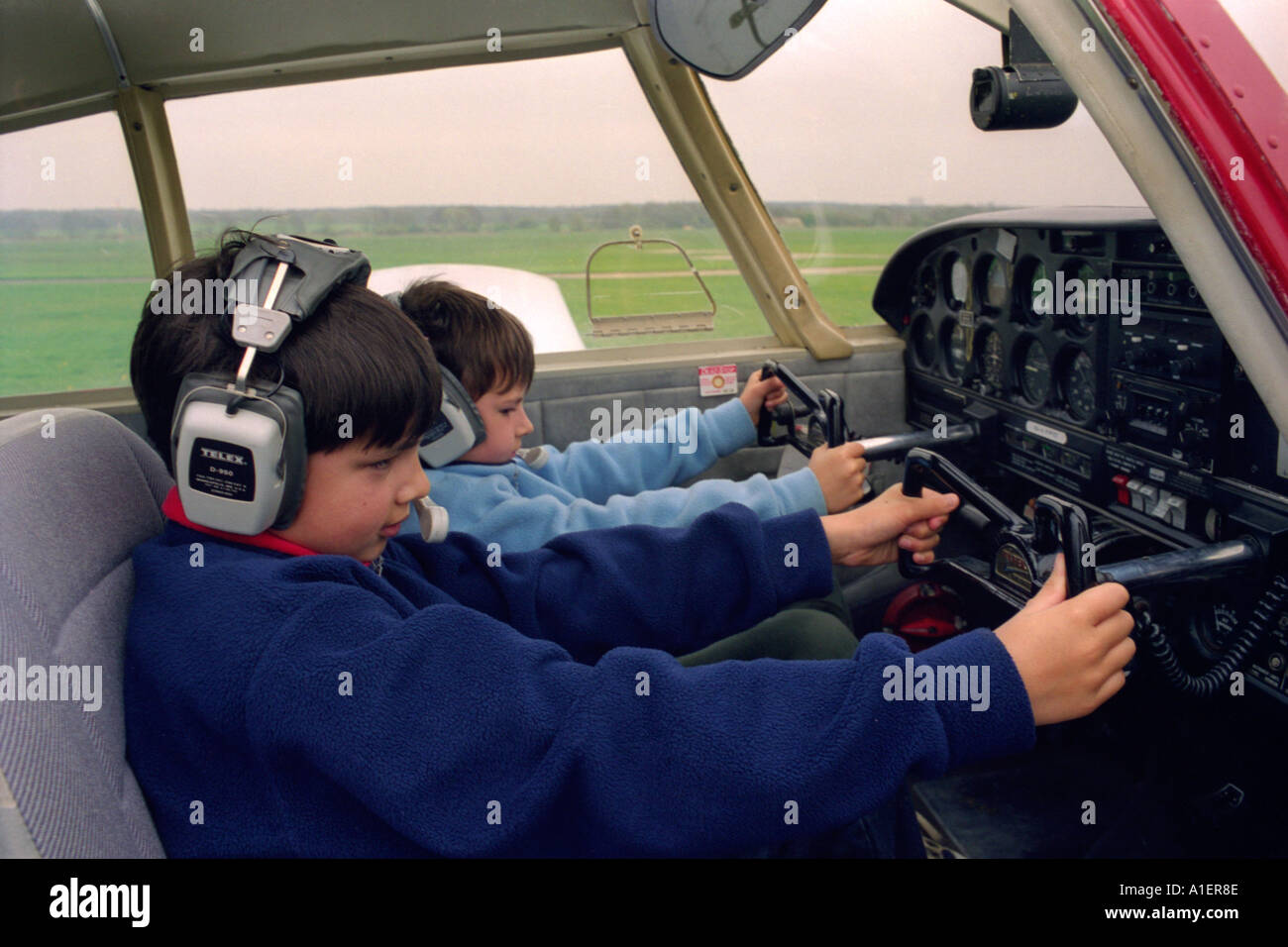 Two young boys in a light aircraft cockpit. London, England, UK Stock ...