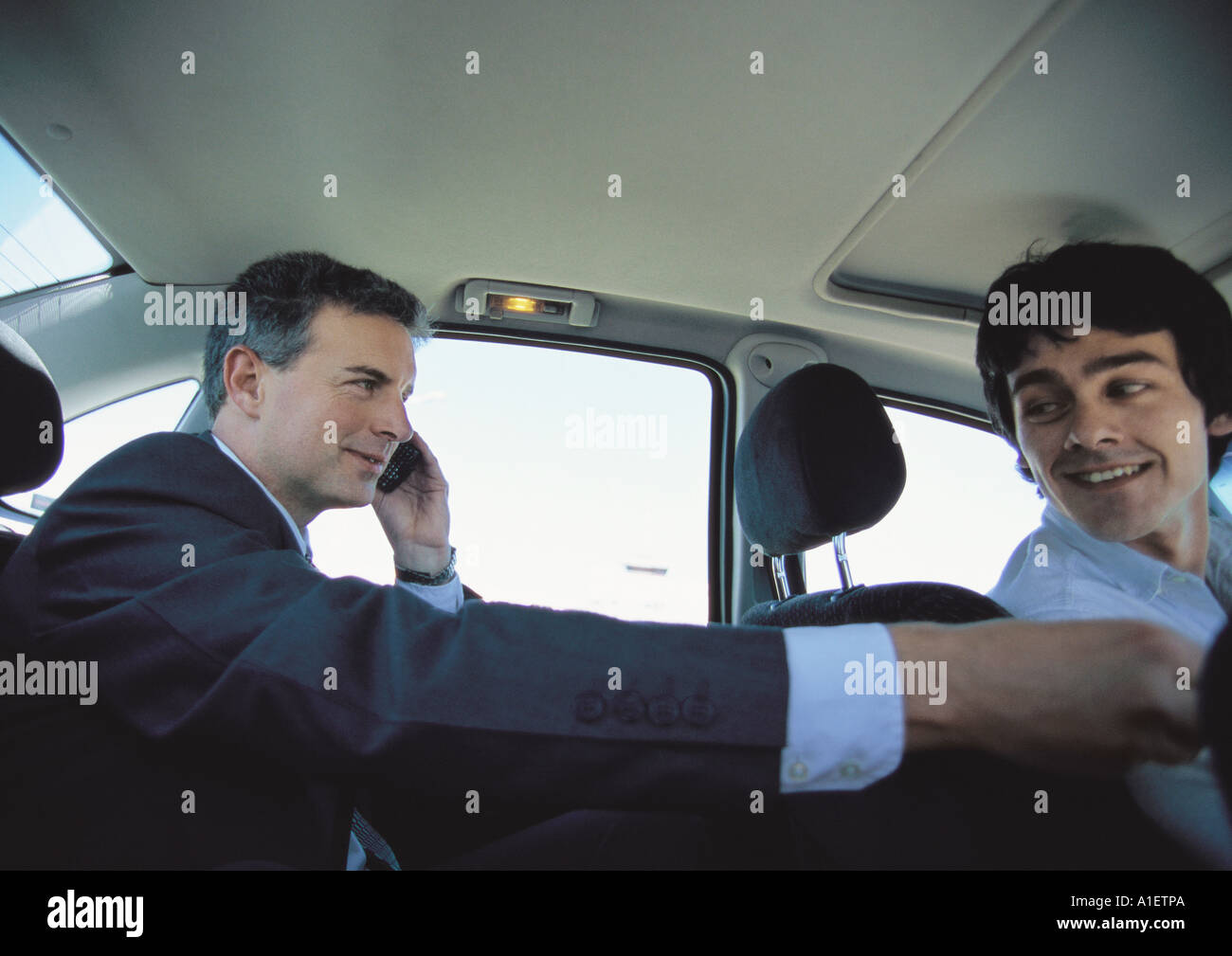 Businessman paying taxi driver Stock Photo - Alamy