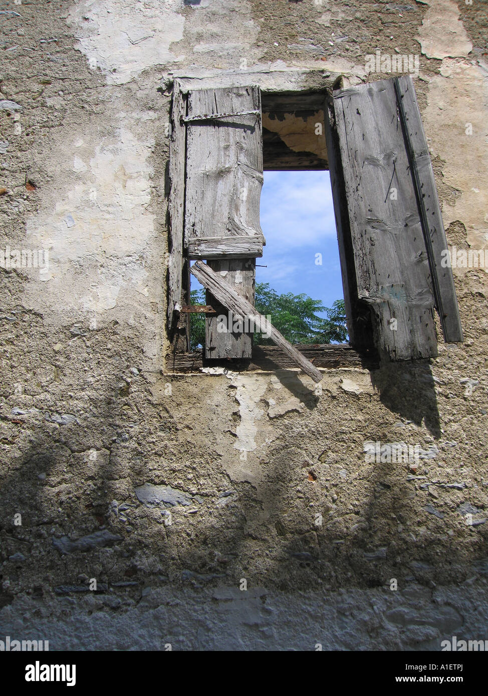 Damaged and decayed shutters hanging from old window frame Alonissos ...