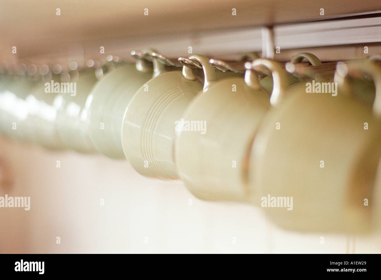 Cups hanging on a rack Stock Photo - Alamy