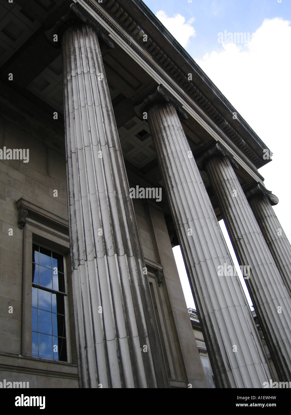 Looking up at the British Museum vertical columns to side of entrance ...
