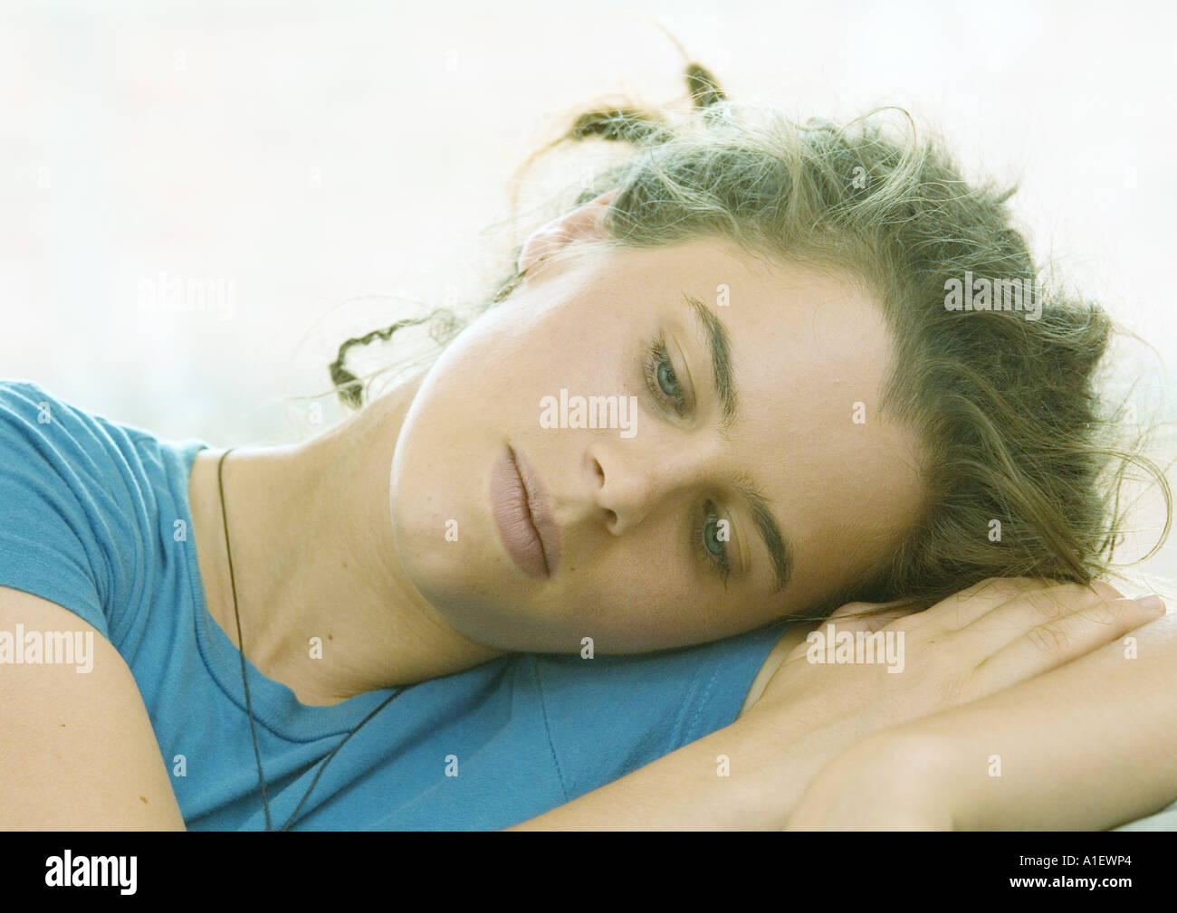 Young woman resting head on arm Stock Photo - Alamy