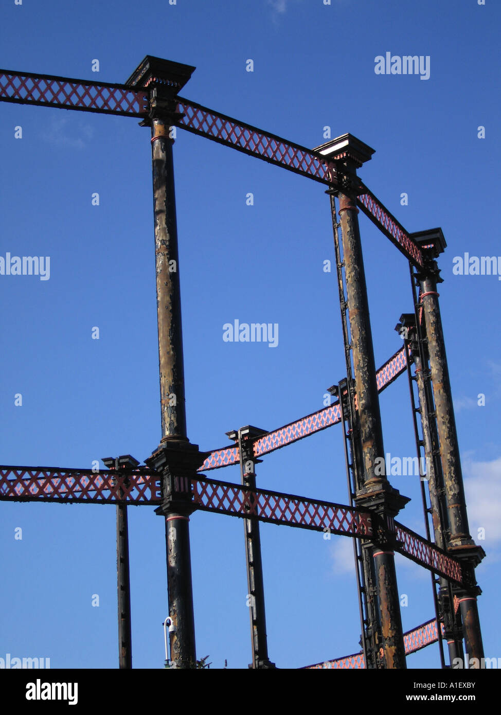 Rusty metal gas tower with blue sky Kings Cross City of London England ...