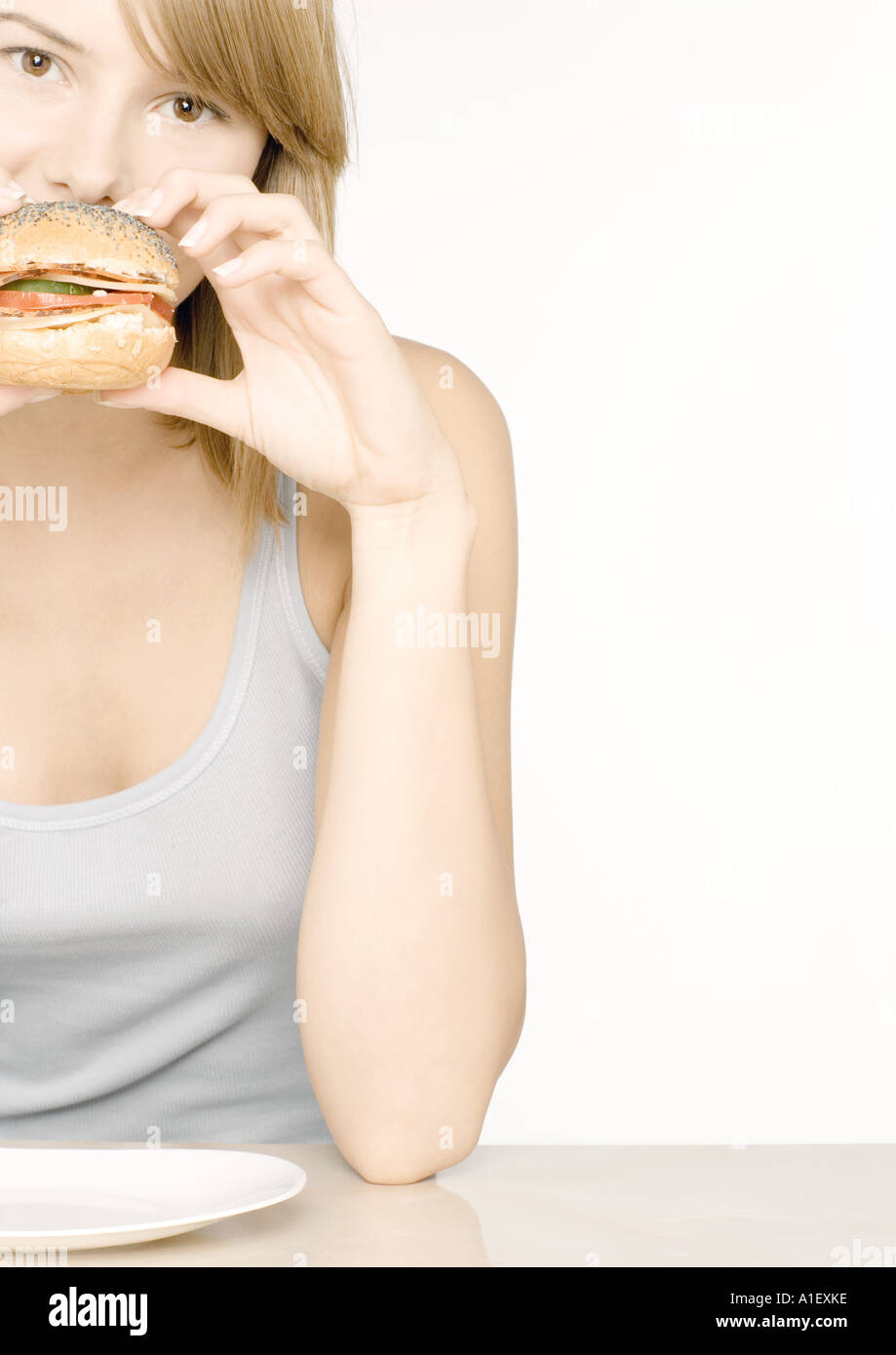 Woman eating sandwich Stock Photo - Alamy