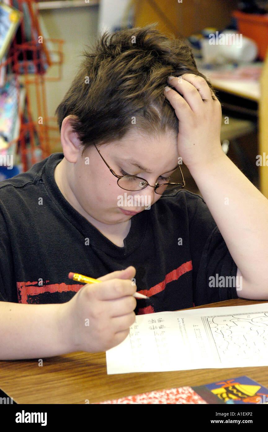 Boy and girl students work alone on an assignment in an Elementary ...