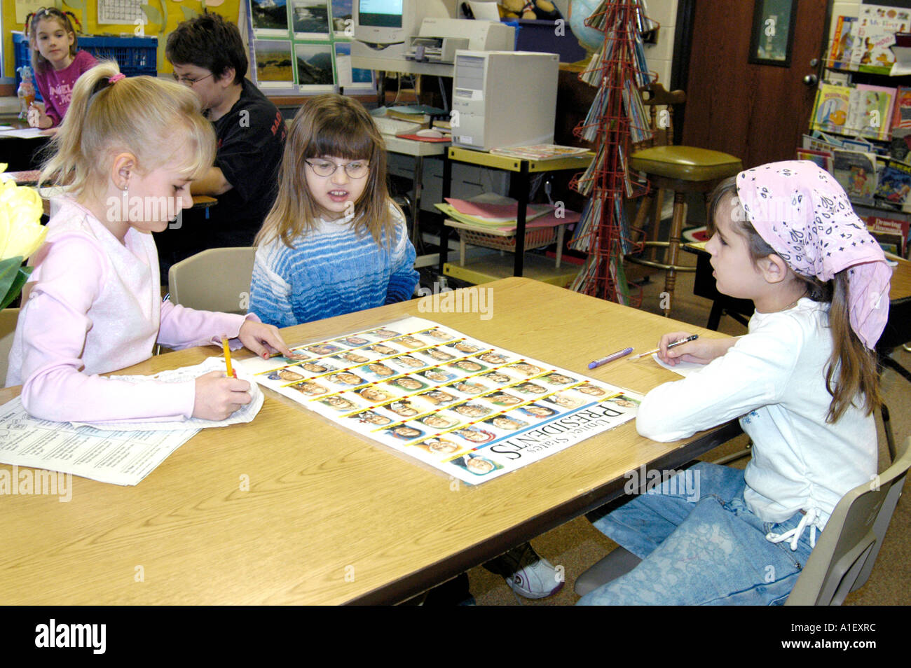 Girl female students working on a project in a teamwork Elementary ...