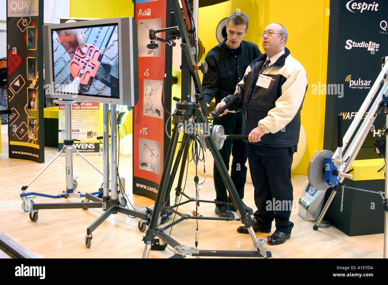 Sales person demonstrating video camera manipulation arm at a ...