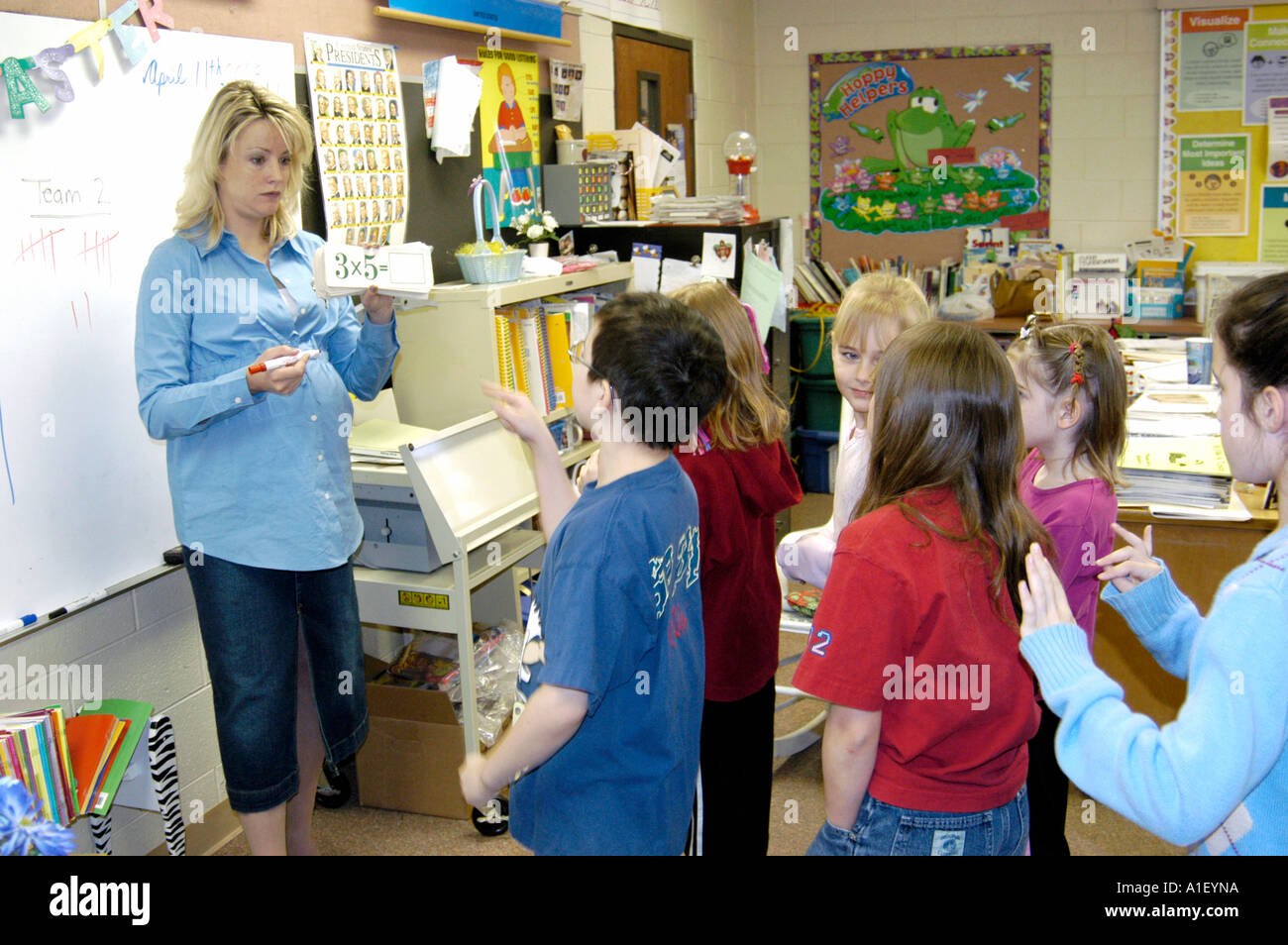 Pregnant woman teacher conducts lessons in her third grade classroom ... Pregnant woman teacher conducts lessons in her third grade classroom ...