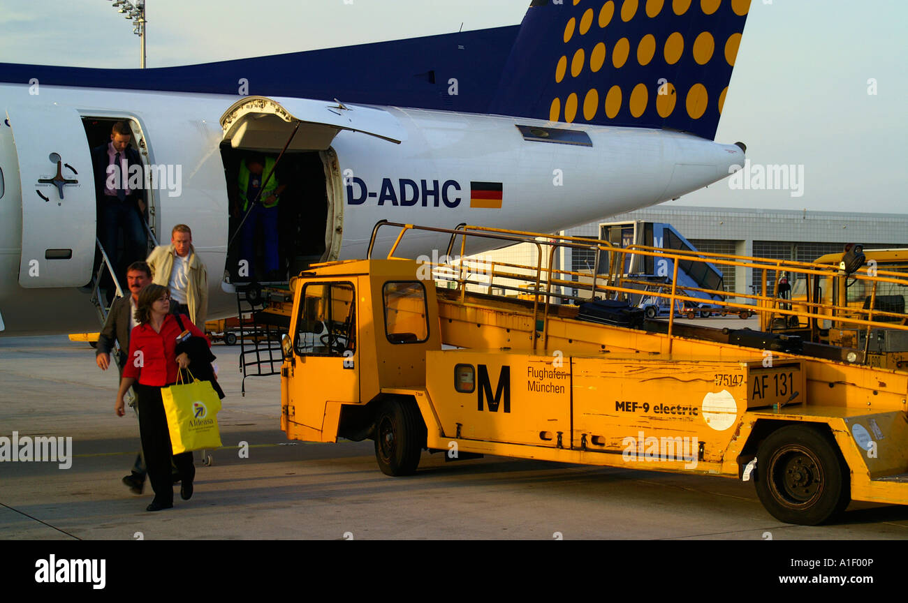 Passengers getting off a jet plane Stock Photo - Alamy