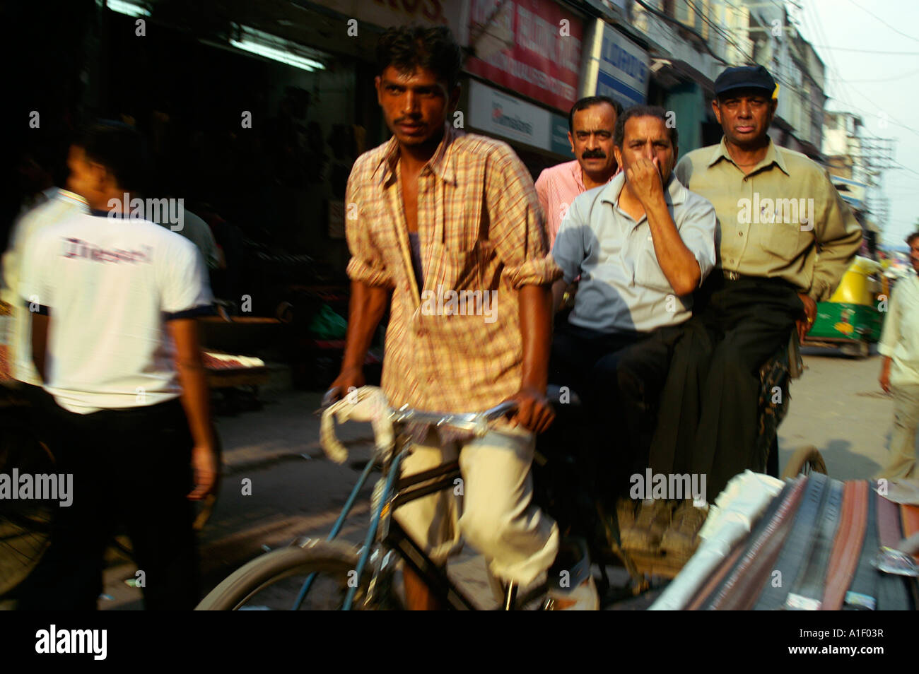 Rickshaw and three men passengers, New Delhi, India Stock Photo - Alamy