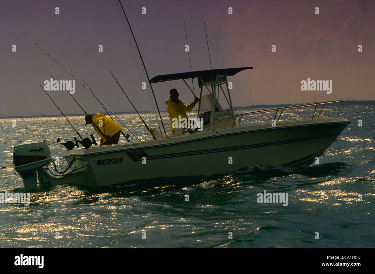 Two men trolling saltwater in outboard boat Stock Photo - Alamy