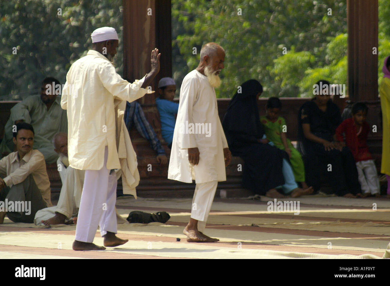 Muslim attendants readying prayer carpets, Jama Masjid mosque, India ...